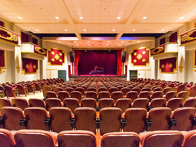 Rows of burgundy seats face the stage in perfect formation, each one holding stories of performances past and audiences enraptured.