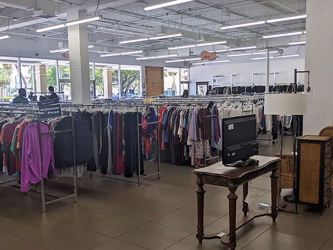 Inside reveals a meticulously organized landscape of possibility – bright lights illuminating endless racks where yesterday's fashion awaits its second chance.