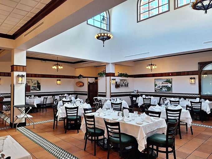 High ceilings, elegant lighting, and crisp white tablecloths create an atmosphere of timeless sophistication where dining becomes an event rather than just a meal.