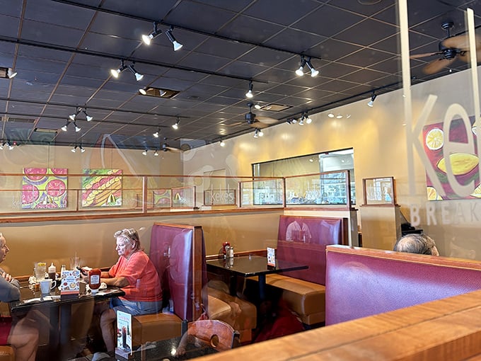 Cozy burgundy booths and warm lighting create the perfect backdrop for morning conversations and pancake feasts at Keke's.
