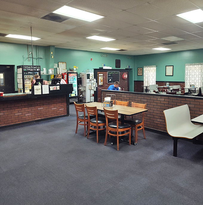 Mint-green walls and brick wainscoting create that perfect "been-here-forever" vibe where comfort trumps trendiness every single time.