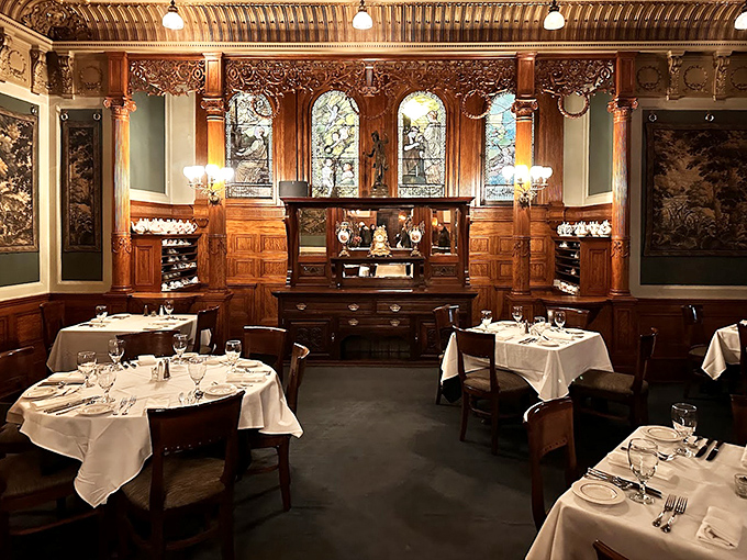 Rich wood paneling, ornate ceilings, and period details transport diners to the Gilded Age in this meticulously preserved dining room.