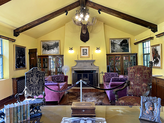 The great room welcomes visitors with vintage purple furniture and a moose head that seems to have wandered straight from Curwood's wilderness tales.