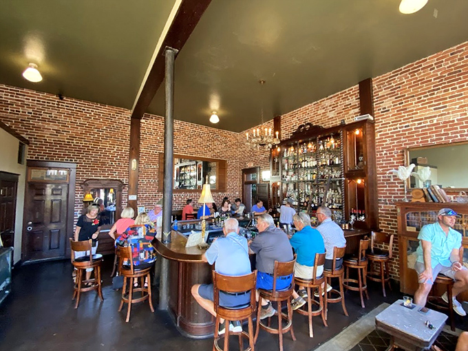 Exposed brick walls and vintage fixtures create an authentic speakeasy vibe where conversations flow as smoothly as the spirits.