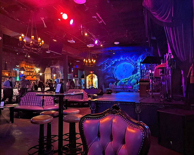 The stage area features plush seating and gothic touches that make every performance feel like a midnight séance.