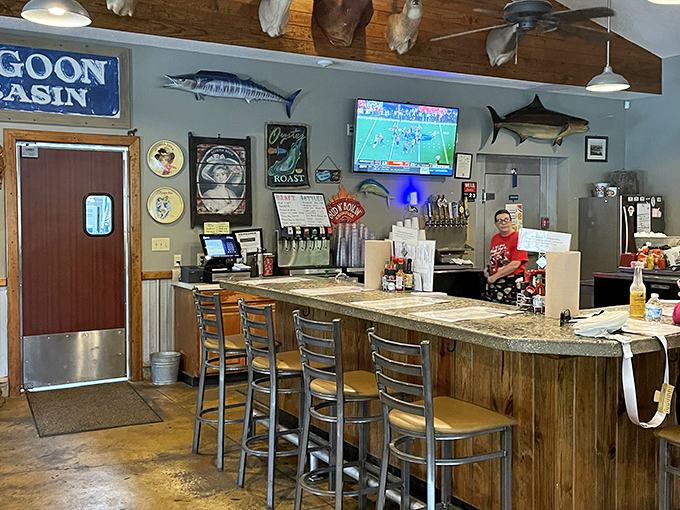 Wooden beams, mounted fish, and nautical touches create an atmosphere that feels authentically Gulf Coast &ndash; earned, not manufactured.