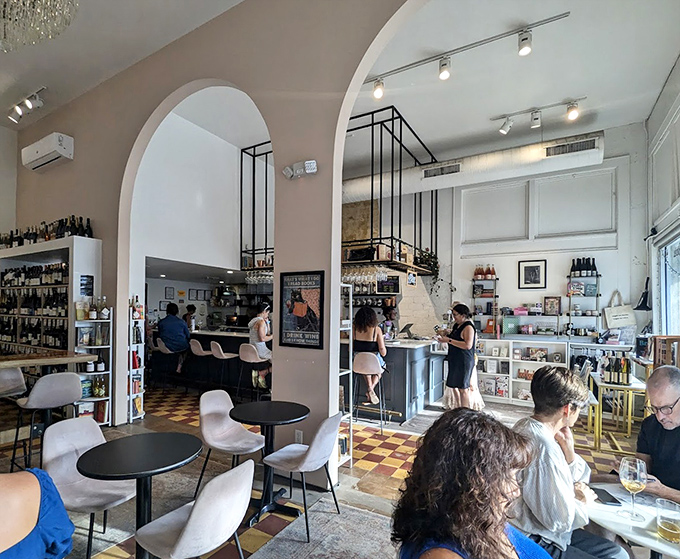 Elegant arches frame this bibliophile's paradise, where checkerboard floors lead you through a wonderland of words and wines.