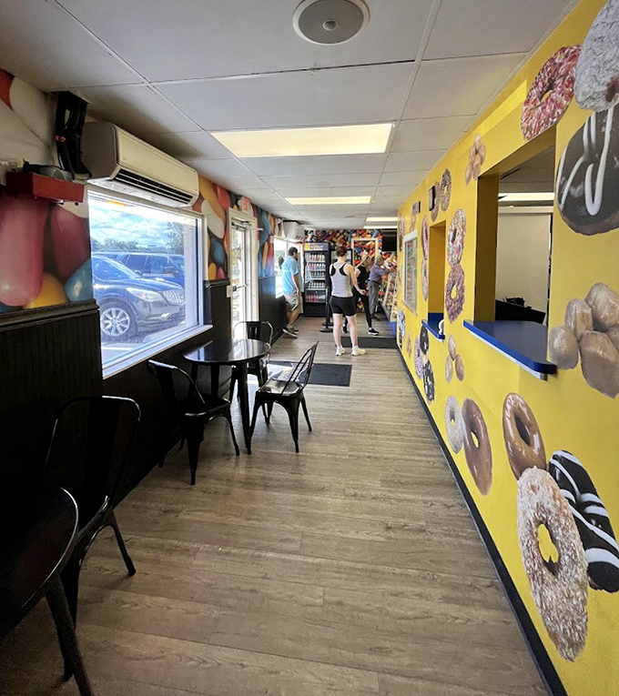 Inside, bright yellow walls and donut-themed decor create a warm, unpretentious atmosphere that feels like breakfast's happy place.