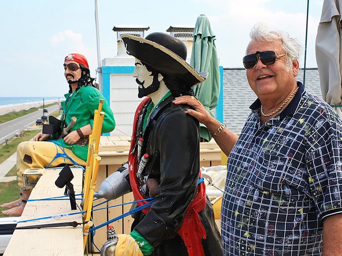 A visitor shares a moment with the stationary crew, proving that even the most hardened sea dogs appreciate good company.