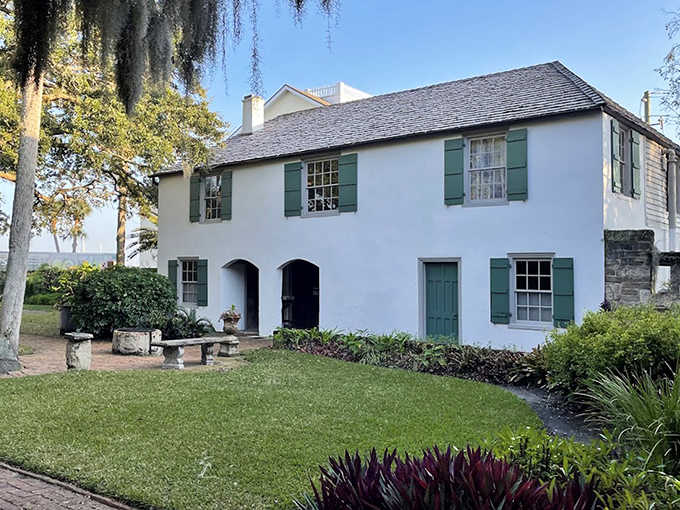 Sunlight plays across the whitewashed walls and manicured lawn, highlighting architectural details that have weathered centuries of Florida's mercurial climate.