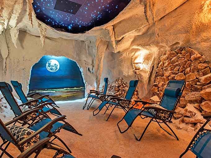 Step into this otherworldly salt room where recliners await beneath a starlit ceiling, offering the beach experience minus sand in uncomfortable places.