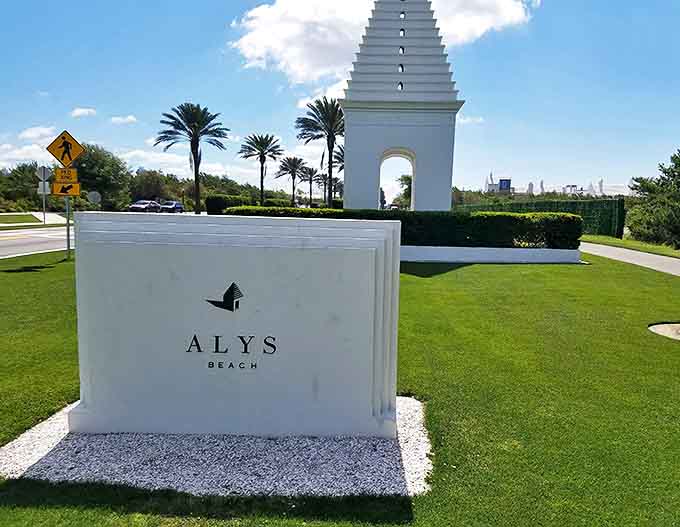The elegant entrance sign to Alys Beach stands as a minimalist welcome, promising the architectural wonders that await beyond.