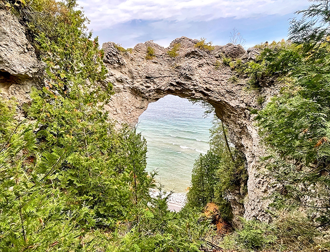 The famous limestone bridge hovers 146 feet above Lake Huron's crystal waters, a geological masterpiece older than the pyramids.