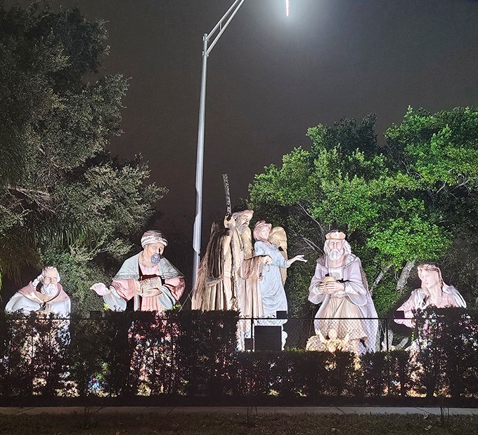 As darkness falls, strategic lighting transforms these colossal figures into a dramatic nocturnal tableau that's both reverent and theatrical.