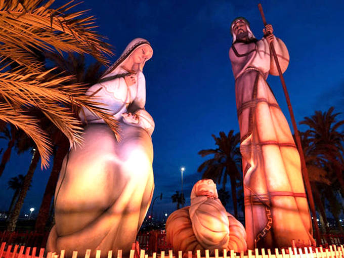 As night falls, these illuminated holy figures create a magical glow against the palm trees, blending Florida's tropical setting with biblical history.