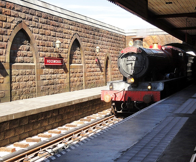 The iconic Hogwarts Express awaits at platform 9&frac34;, ready to whisk wizards and muggles between magical worlds.
