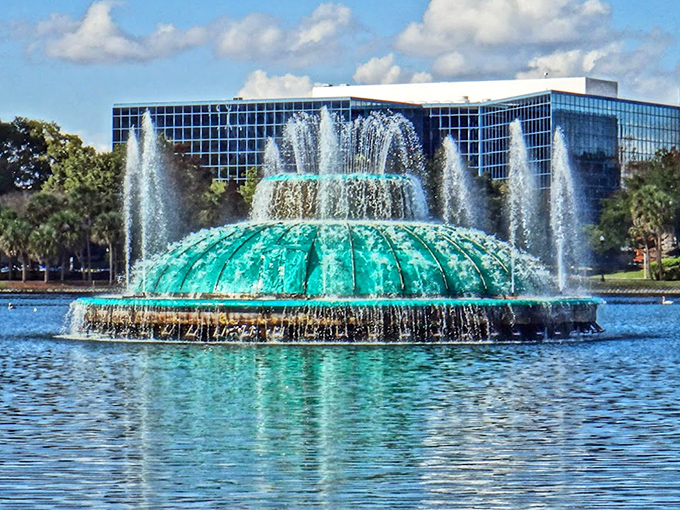 Lake Eola's iconic green fountain creates a striking centerpiece in downtown Orlando, its turquoise dome floating like an alien spacecraft.