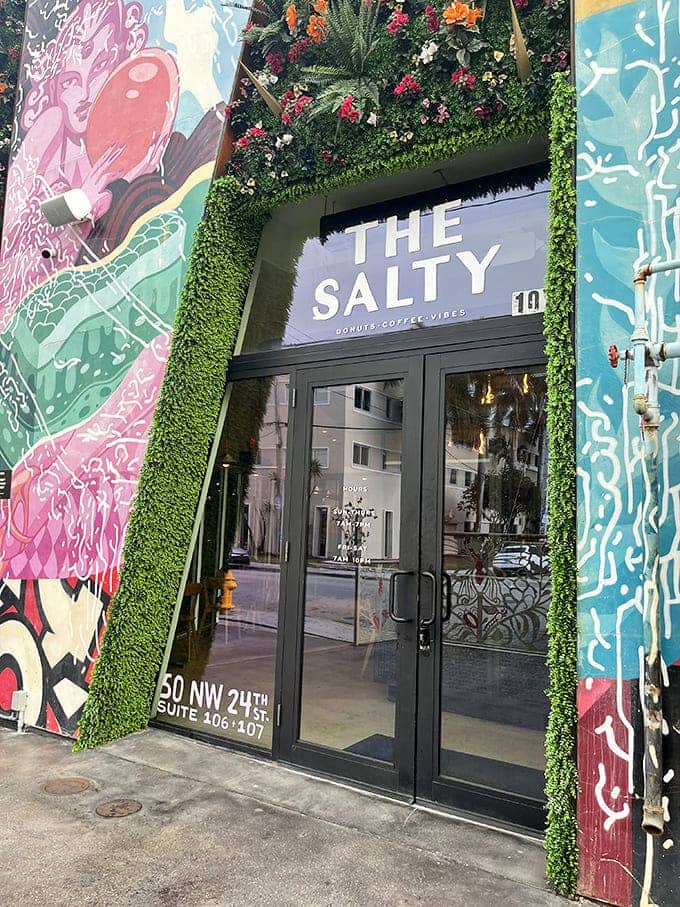 The Salty Donut's artistic entrance, framed by vibrant murals, hints at the creative flavors waiting inside.