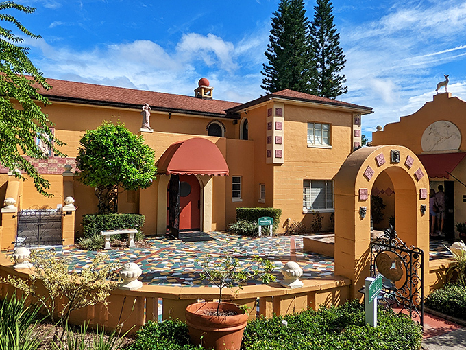The golden buildings glow in Florida sunshine, framing a peaceful courtyard where art and architecture blend in perfect harmony.