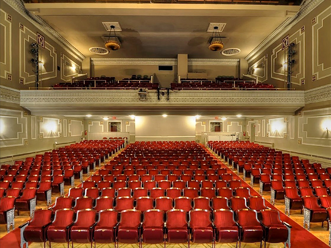 Row upon row of crimson seats await their audience, each one offering a perfect vantage point for the evening's entertainment.