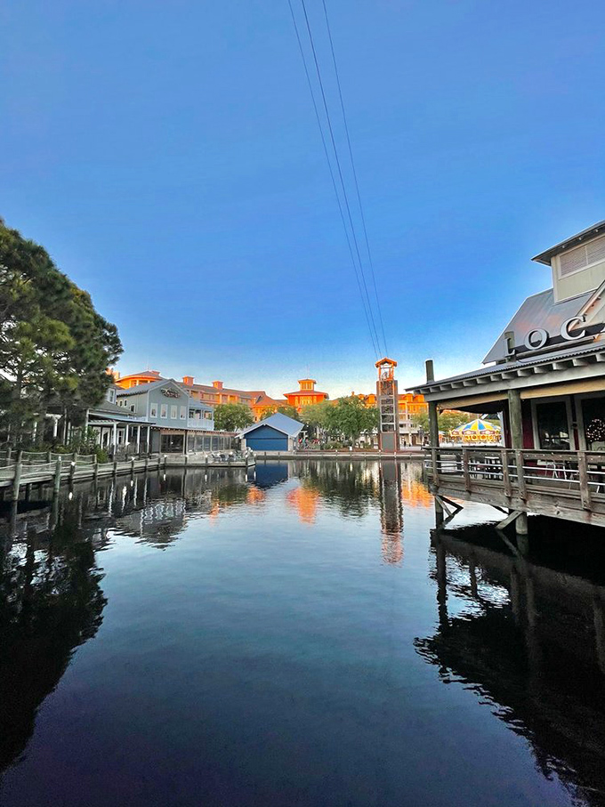 Mirror-like waters double the visual delight, reflecting buildings that seem to have been designed by someone who believes life should be colorful.