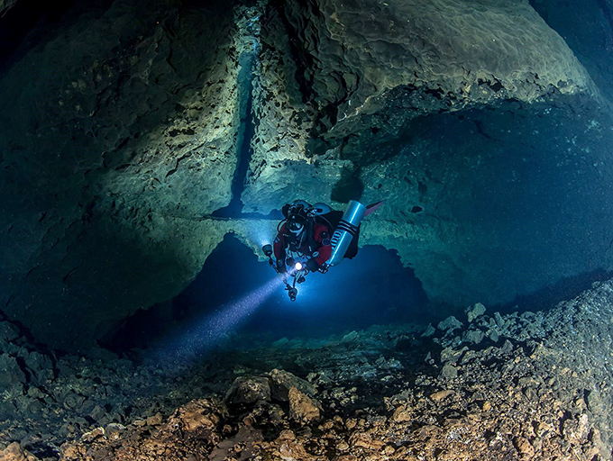 A diver navigates the limestone passages of Manatee Springs' underwater cave system&mdash;Florida's own subterranean Grand Canyon.