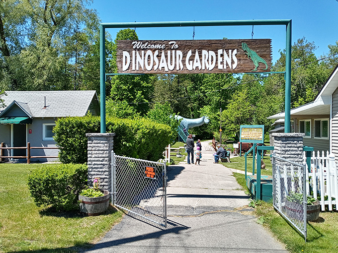 "Welcome to Dinosaur Gardens" – the rustic entrance sign marks the threshold between our world and a Jurassic fantasy.