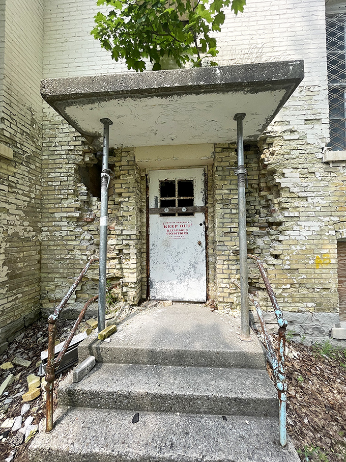 This weathered entrance, now secured against unauthorized visitors, once served as a portal between the underground world and daily hospital operations.