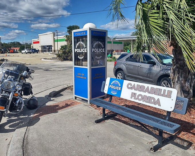Even the vehicles parked nearby dwarf this miniature marvel of municipal ingenuity. Superman would be confused!