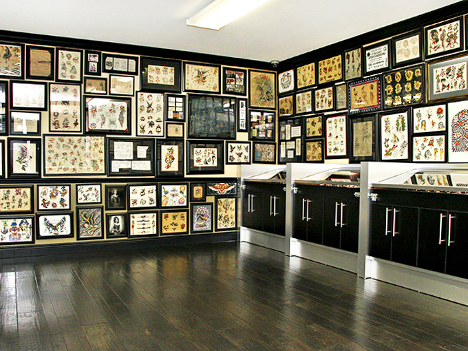 Every framed piece tells a story &ndash; traditional American tattoo art preserved in all its bold-lined, vibrant glory.