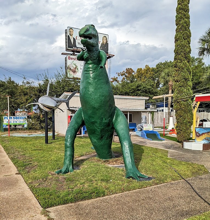 The legendary green dinosaur stands guard like a prehistoric sentinel, having witnessed decades of family memories and countless errant putts.