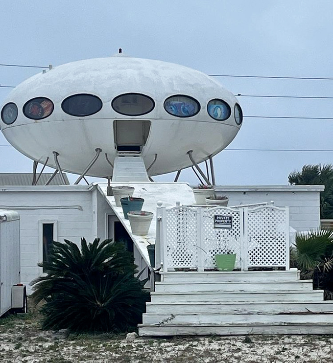 The stairway to the stars! White steps lead earthlings up to this otherworldly dwelling that seems to hover above the sandy terrain.