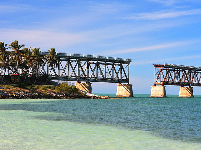 Engineering meets paradise: The historic rail bridge stands like an industrial sculpture against nature's canvas, telling stories of ambition and hurricanes past.