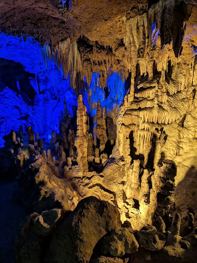 The cave's dramatic lighting transforms ordinary minerals into extraordinary spectacles, like nature's own Broadway production.