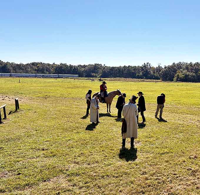 History comes alive as visitors gather around period-dressed performers, creating an immersive experience that bridges centuries with authentic flair.