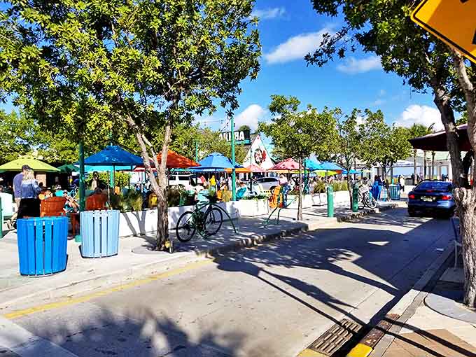 Colorful umbrellas dot the landscape like confetti, creating impromptu neighborhoods of beach-goers sharing nothing but sunshine and good vibes.