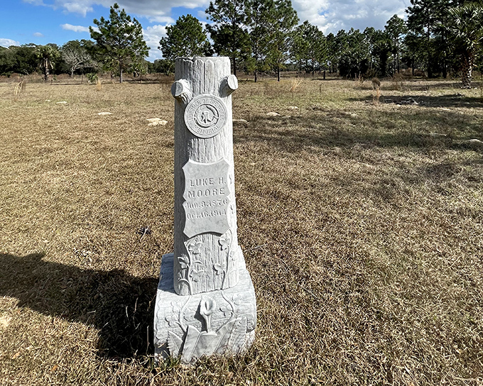 Luke H. Moore Tombstone: Victorian craftsmanship meets Florida wilderness in this distinctive tree-trunk monument, symbolizing a life rooted in simpler times.