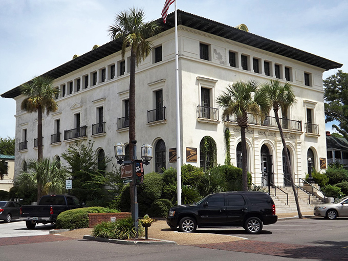 This Mediterranean-style masterpiece stands regally among palm trees, like a European count who decided Florida winters beat the Alps.