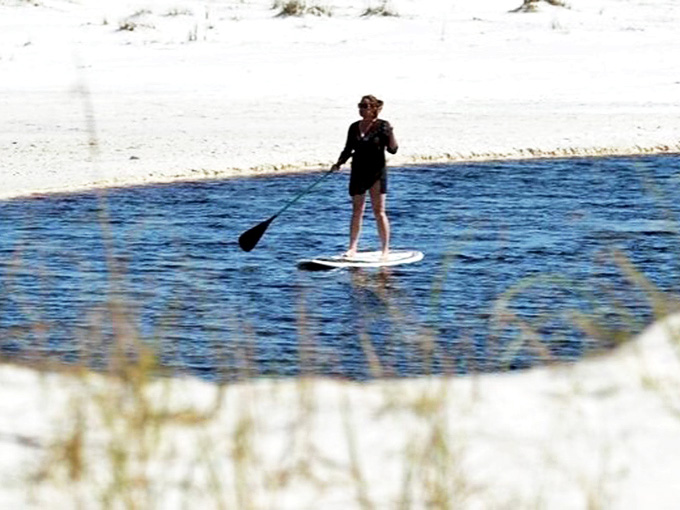 Peaceful paddleboarding on Western Lake's glassy surface &ndash; nature's version of therapy, just add water and sunshine.