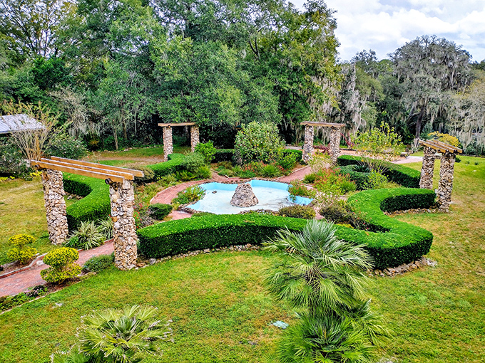 Ravine Gardens' formal landscape showcases stone columns, manicured hedges, and a serene fountain &ndash; Florida's answer to European garden design.