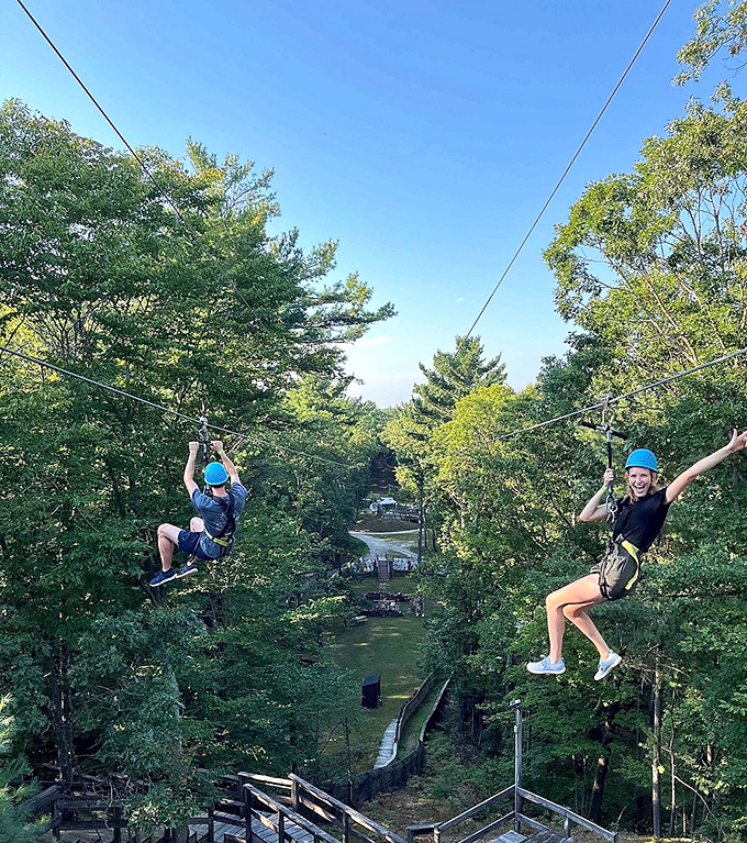 Summer greenery creates the perfect backdrop for aerial adventures, where strangers become instant friends connected by shared courage and steel cables.