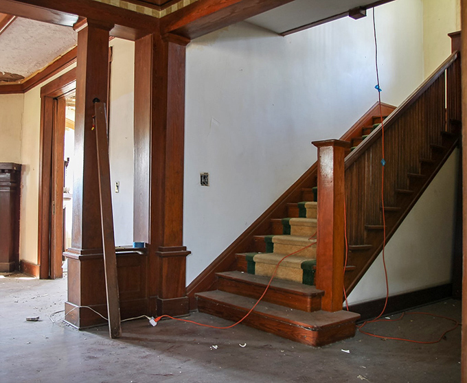 Wooden banisters tell silent stories of hands that once glided along their surface, leading visitors between worlds of upstairs and down.