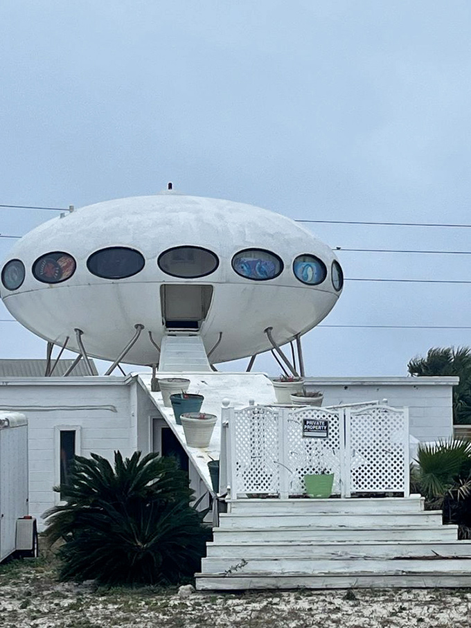 The retractable stairway beckons visitors upward, like a cosmic invitation to the most unusual beach house open house ever.