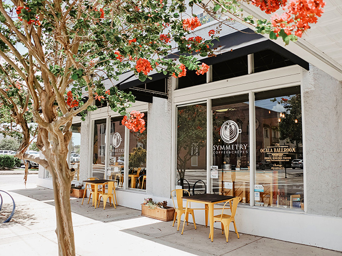 Symmetry Coffee Company's inviting storefront, where locally-roasted beans and vibrant outdoor seating create the perfect morning ritual for adventure planning.