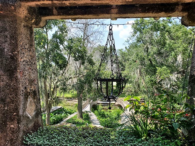 Hanging through archways that frame the gardens beyond, this vintage chandelier holder suggests parties that would put today's Pinterest boards to shame.