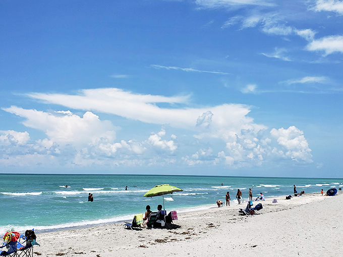 Beachgoers enjoy the perfect combination of shell hunting and relaxation under Florida's brilliant blue skies and gentle waves.