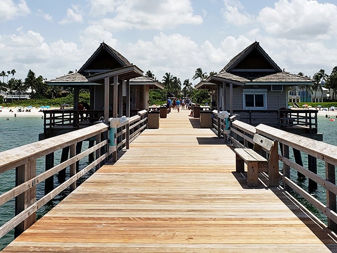 The iconic Naples Pier stretches toward the horizon, offering visitors the perfect vantage point for dolphin spotting and legendary sunsets.