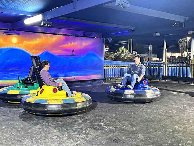Colorful bumper cars await their next drivers in a neon-lit arena where road rage is not only permitted but encouraged.