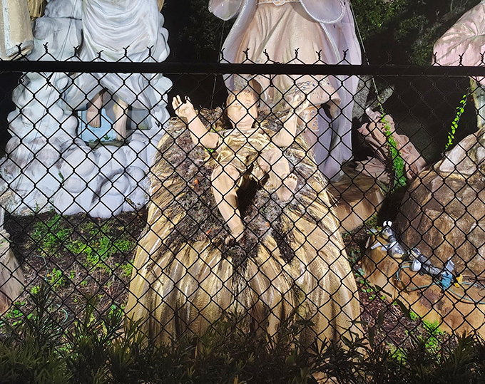 Even through chain-link fencing, the detail on these mammoth sculptures is apparent&mdash;every fold and feature meticulously crafted at superhuman scale.