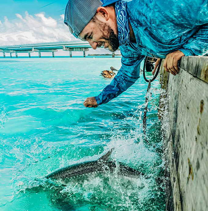 The moment of truth! A massive tarpon launches from the crystal-clear water, creating an adrenaline rush that's worth every penny.